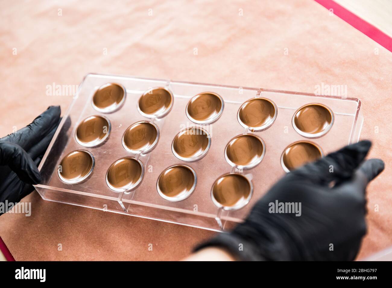 Chef or chocolatier making sweet chocolates home on background of ...