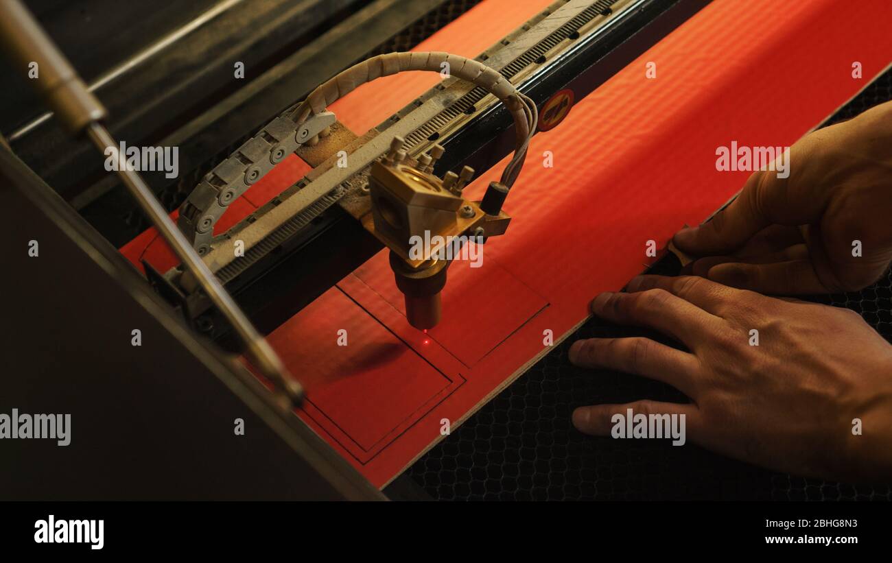 Laser cutting beam high precision on a paperboard. Modern machine ...