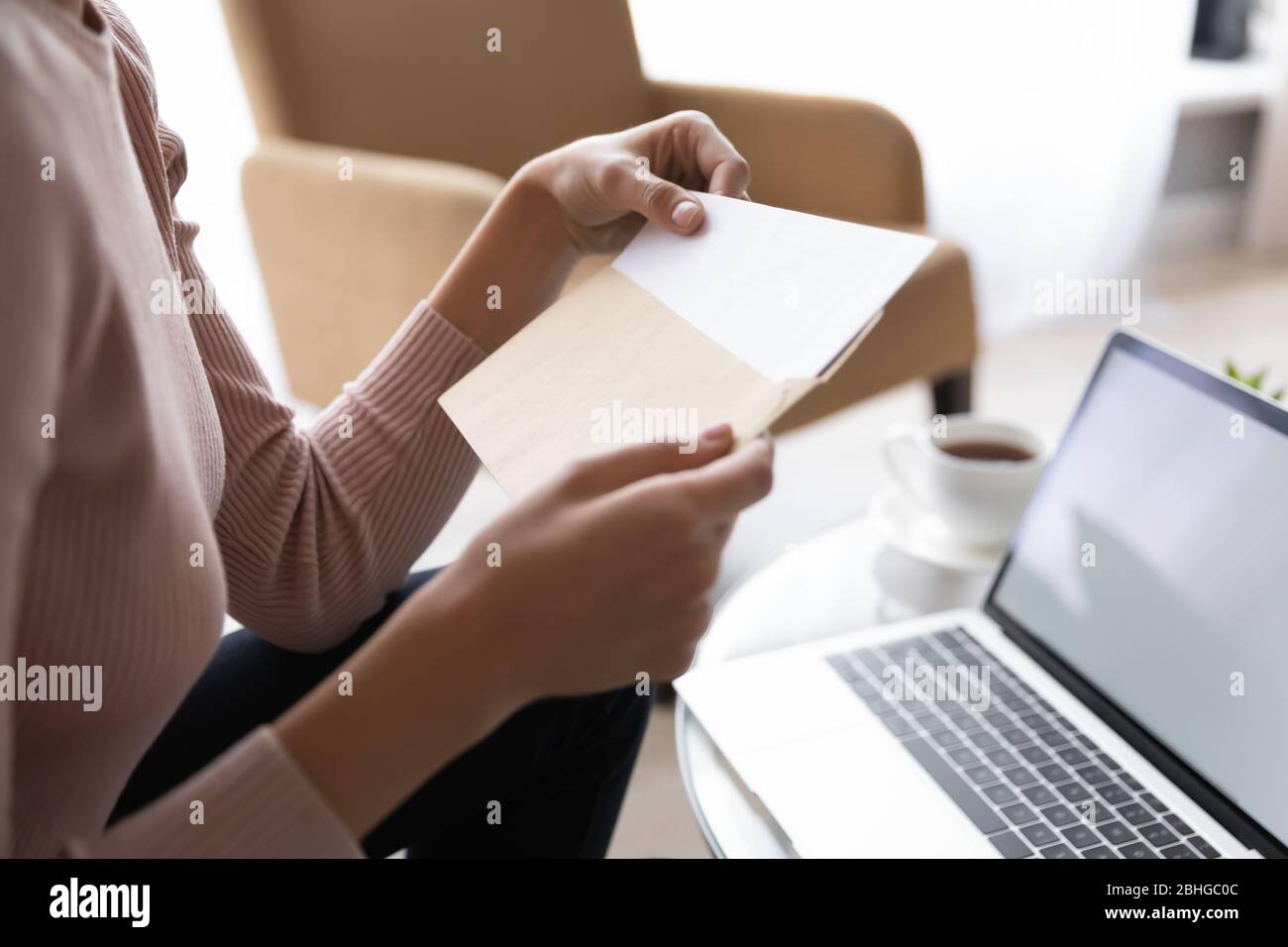 Close up side view young woman holding craft paper envelope Stock Photo ...