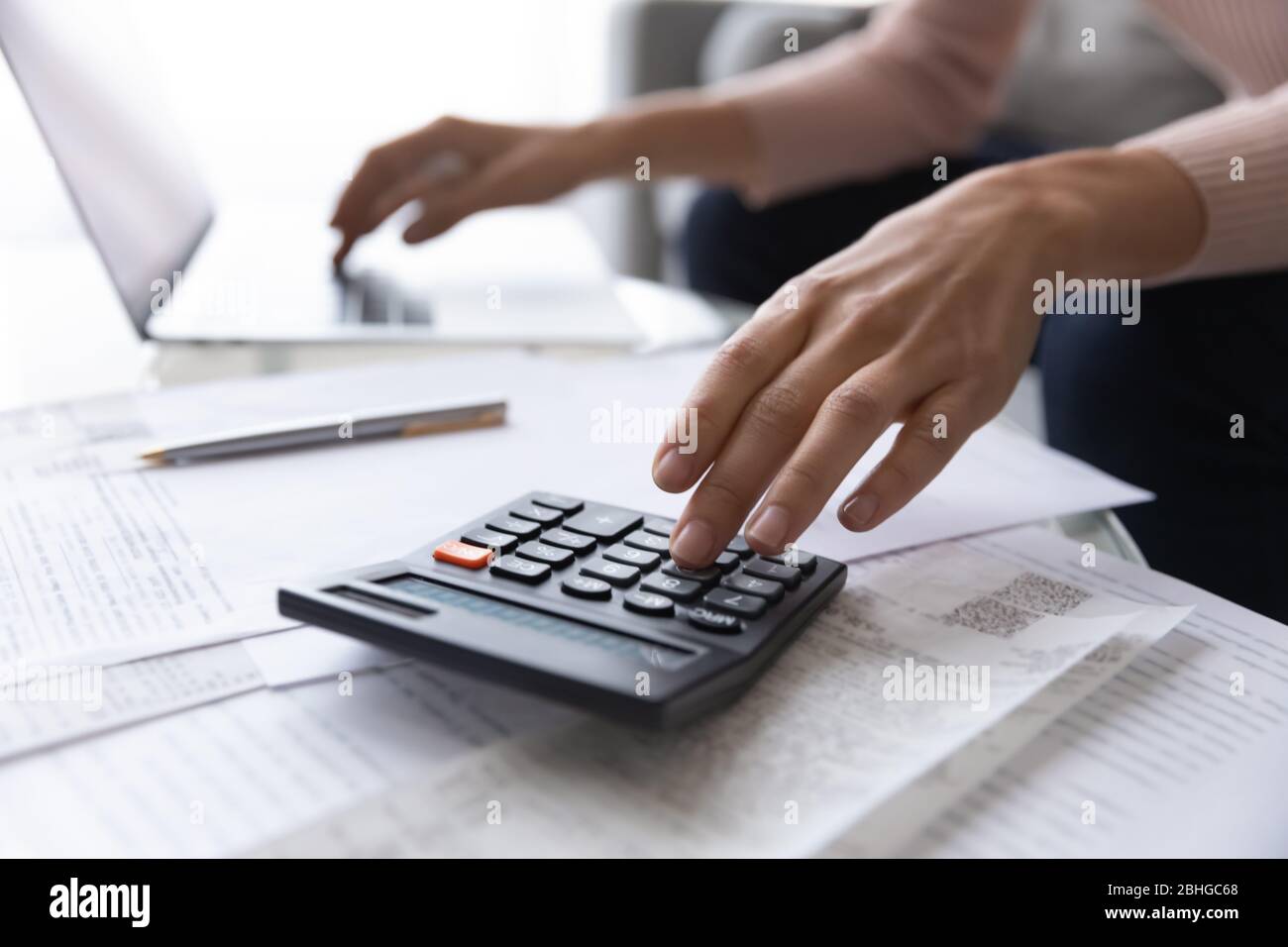 Close up focus on female hands making calculations Stock Photo - Alamy
