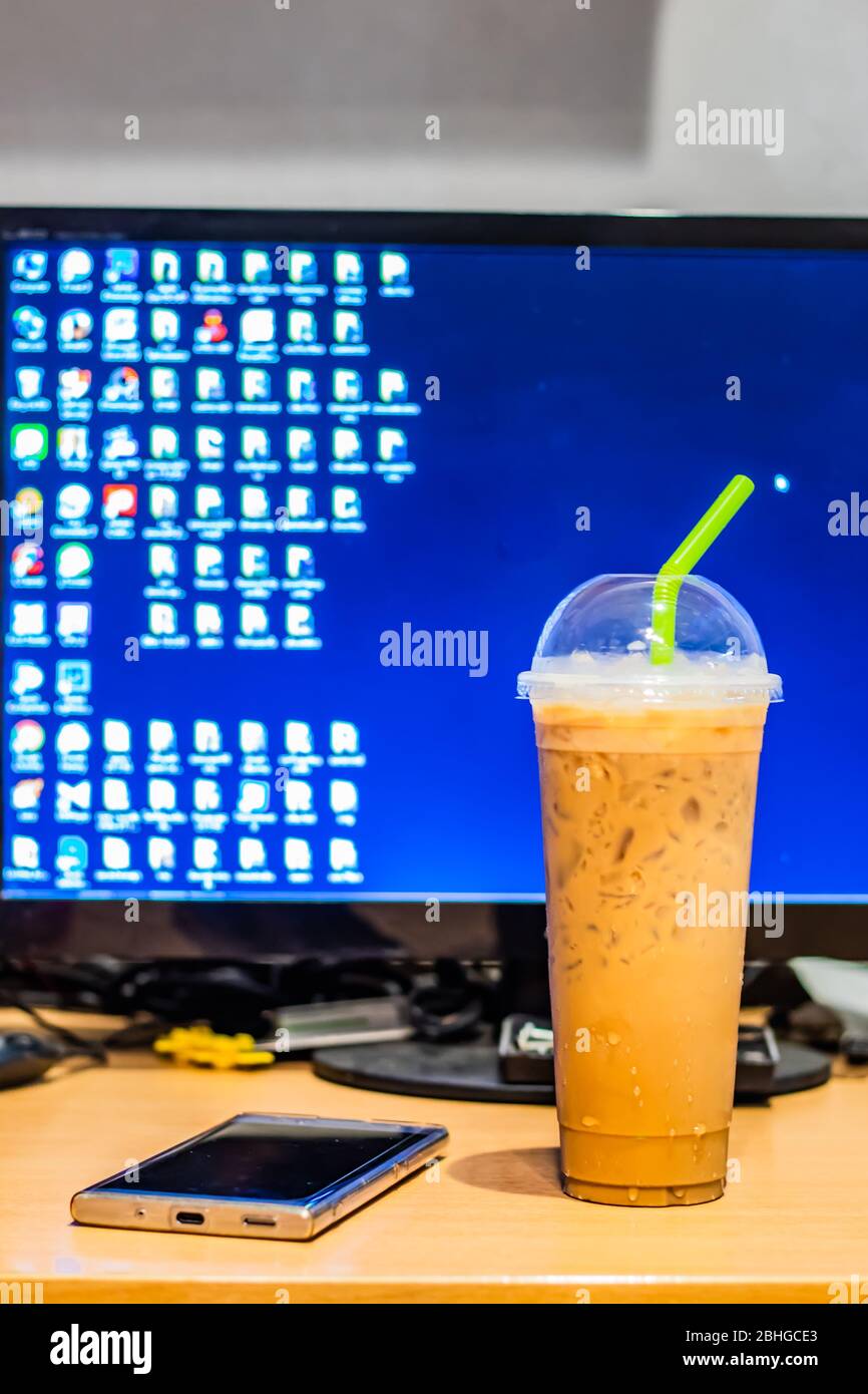 Iced coffee on the computer table filter Stock Photo - Alamy