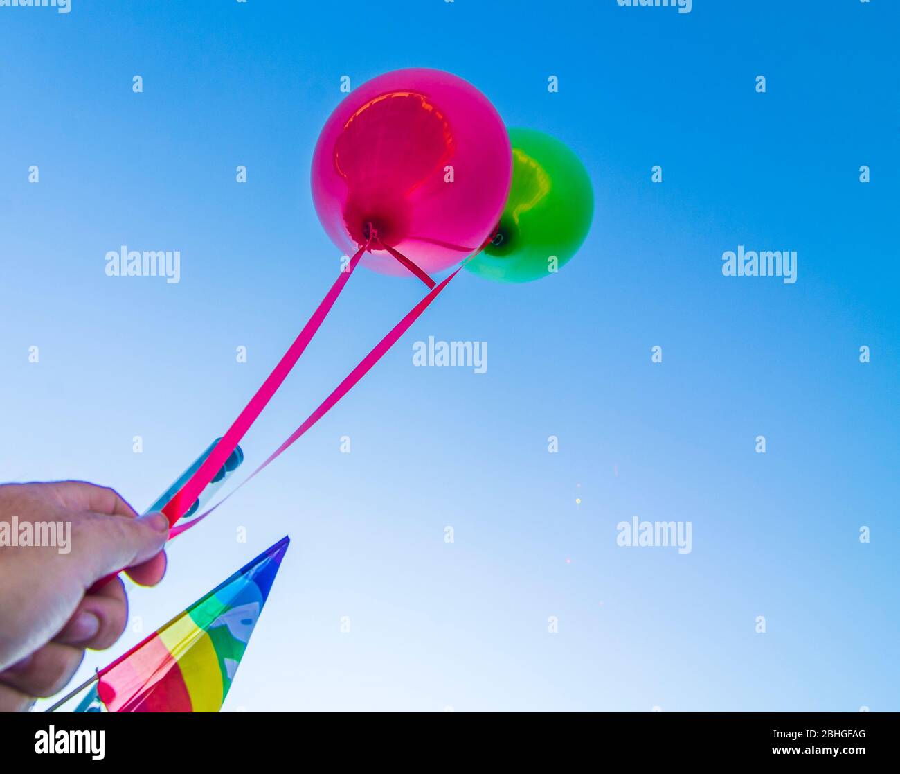 seller holds colorful balloons ready for children Stock Photo - Alamy