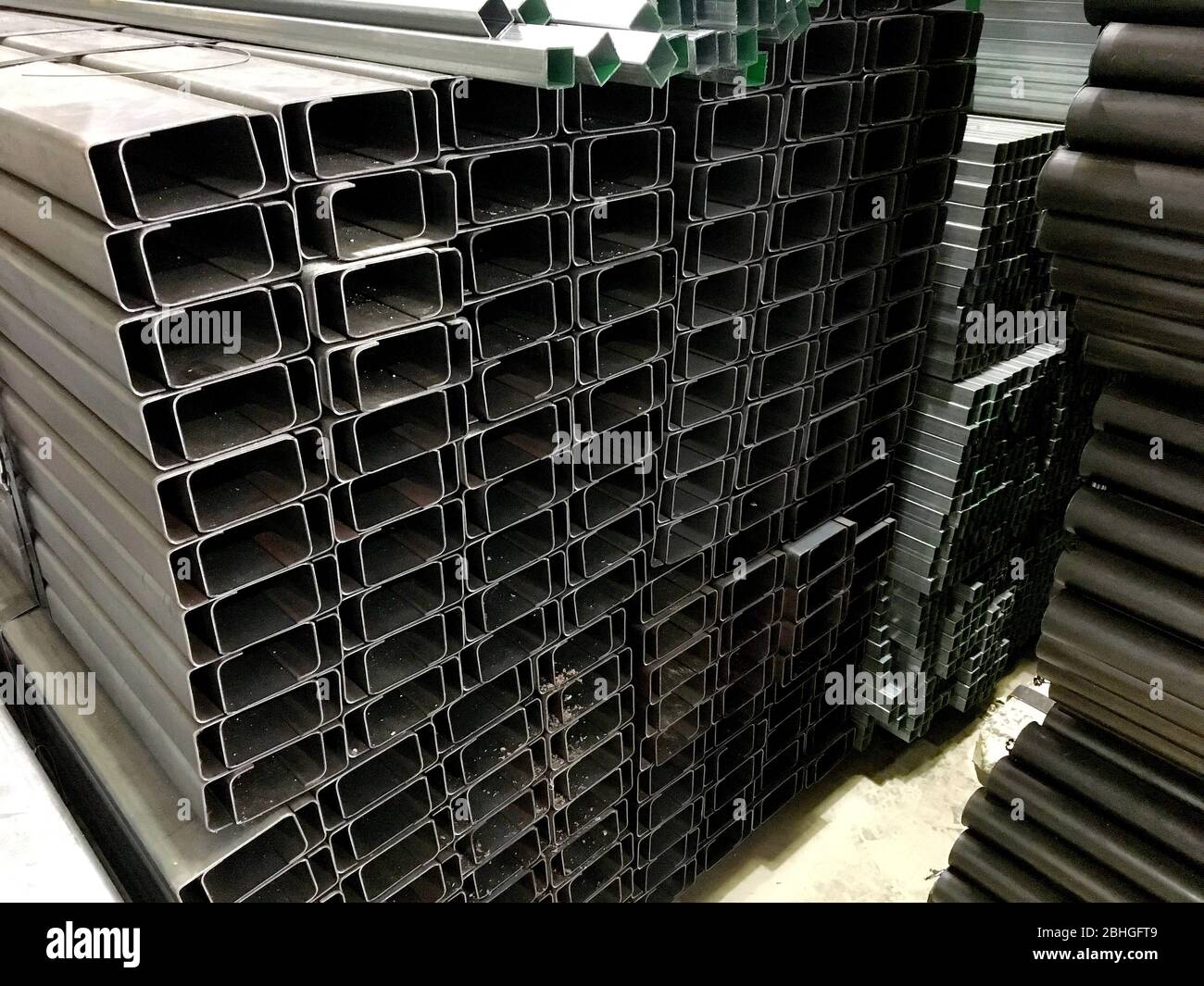 Pile of balck metal bars with different size Stock Photo - Alamy