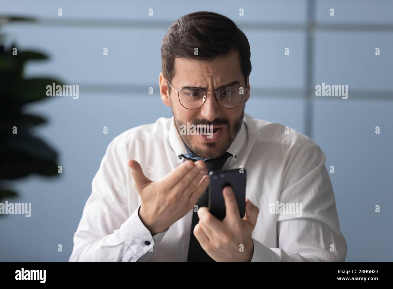 Frustrated businessman angry over bad news message on smartphone Stock ...