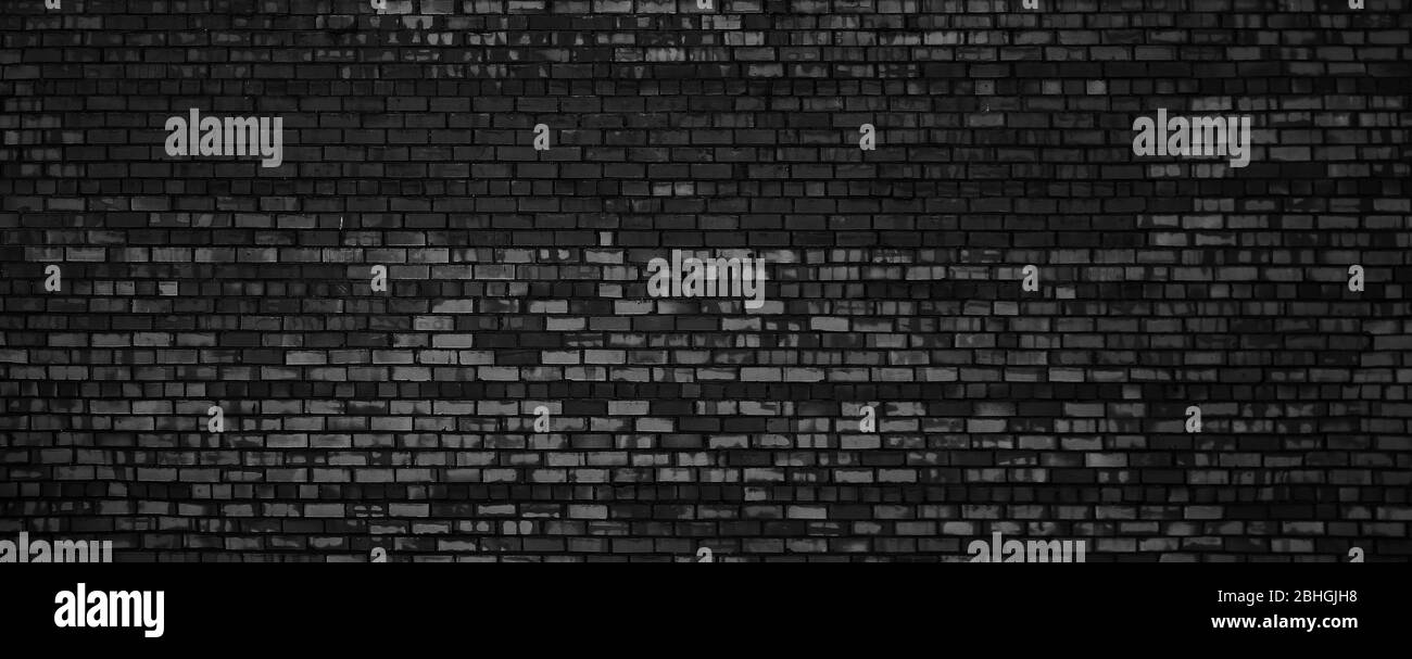Old weathered black brick wall, wide banner layout Stock Photo - Alamy