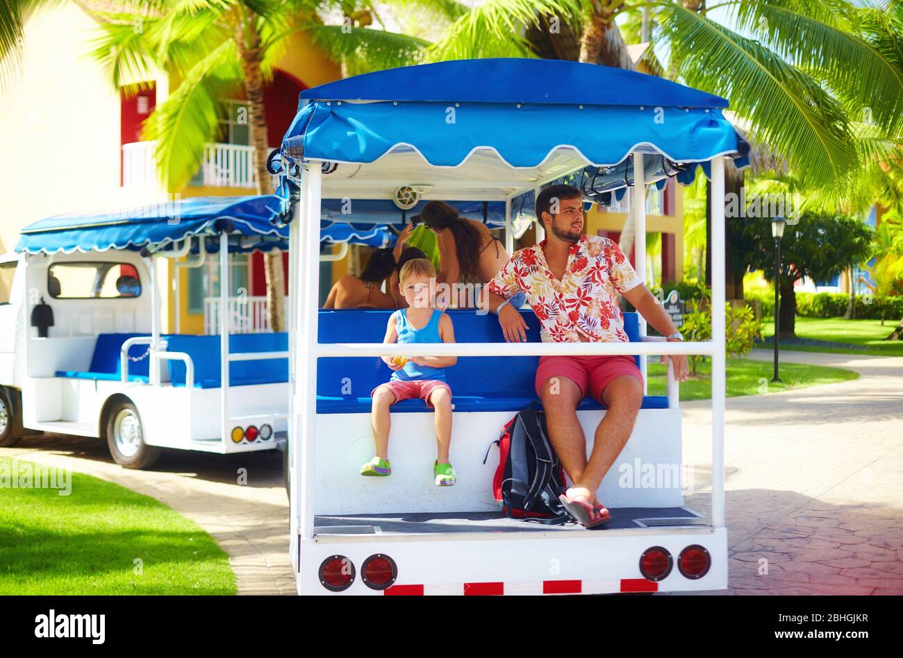 happy tourist family enjoying vacation while riding in vehicle through ...