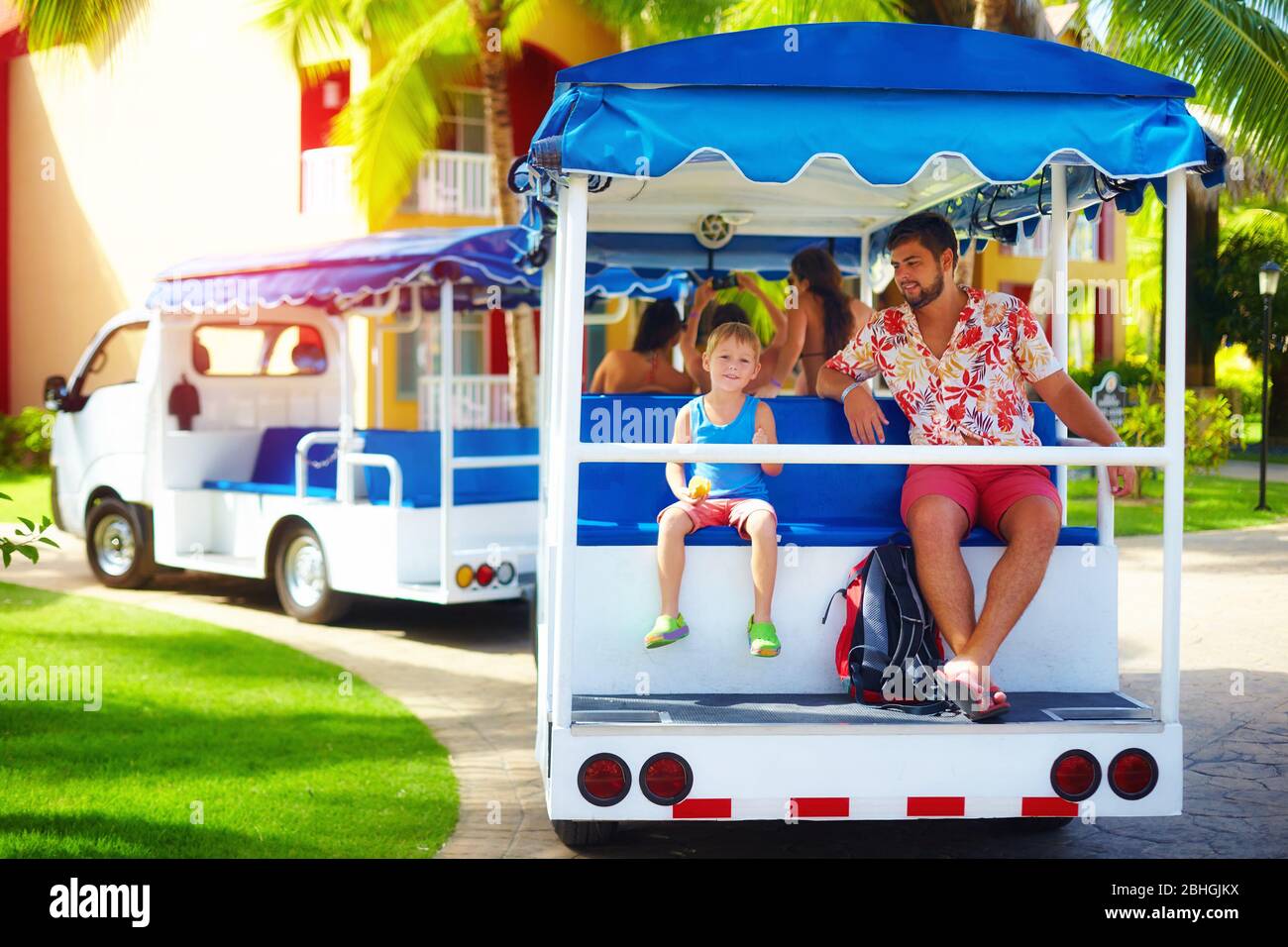 happy tourist family enjoying vacation while riding in vehicle through ...