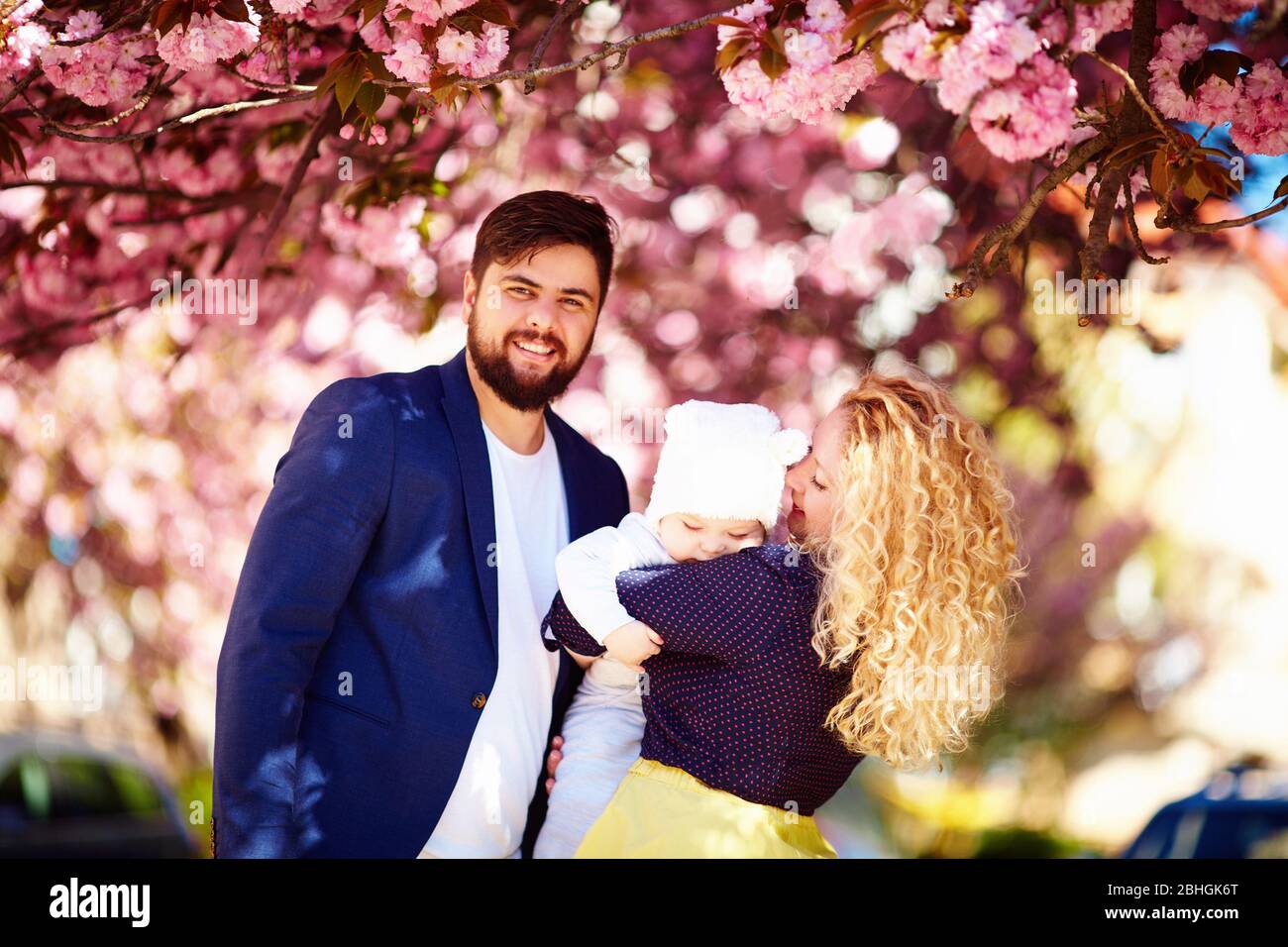 portrait of happy family in blooming spring park Stock Photo - Alamy