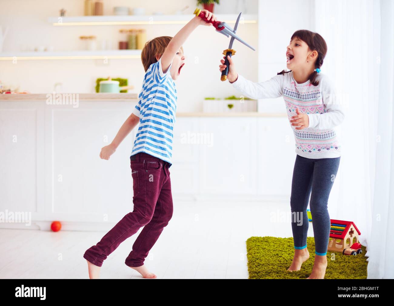 kids playing active fight games at home kitchen Stock Photo - Alamy