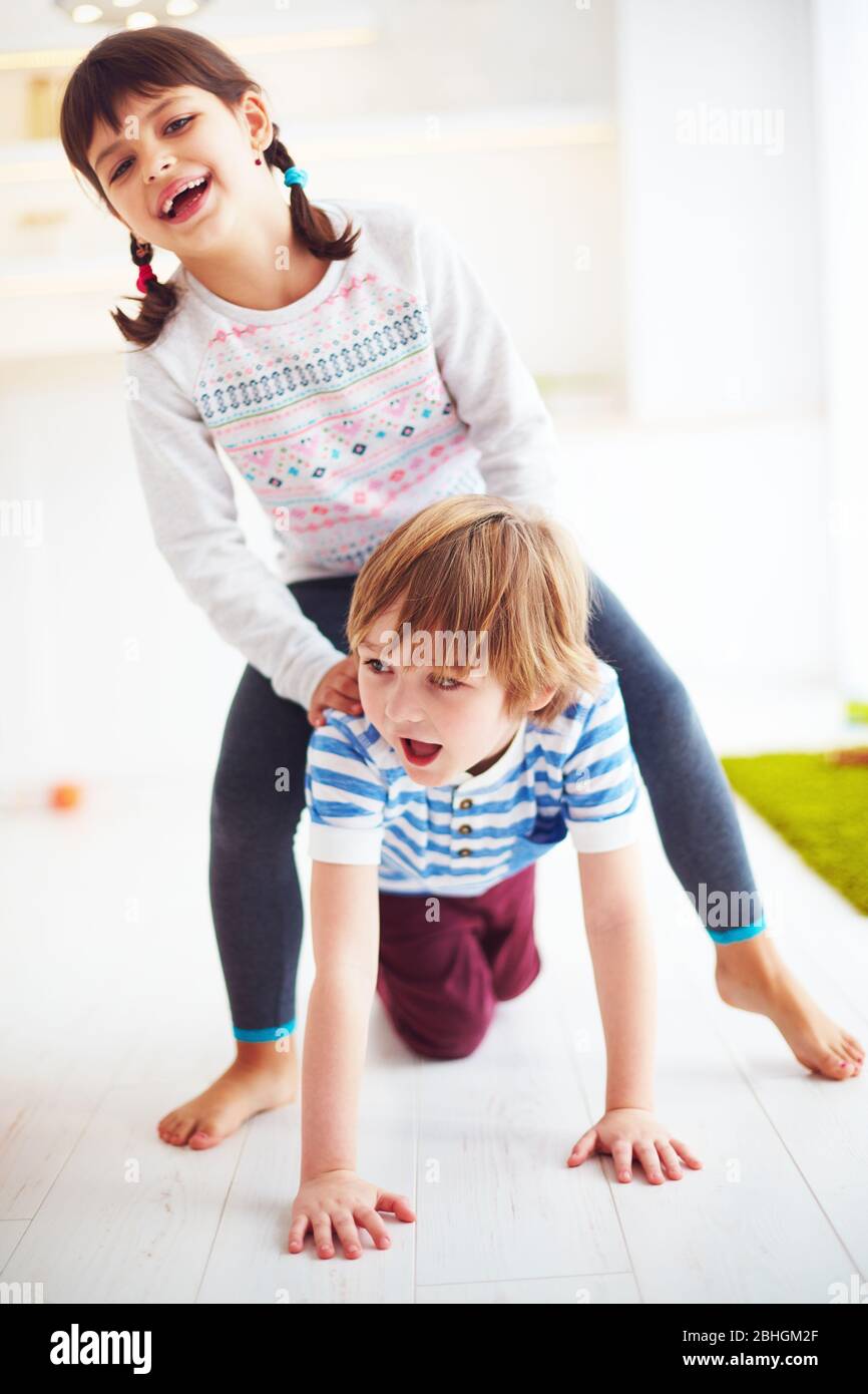 happy excited kids having fun , riding on the back at home Stock Photo ...
