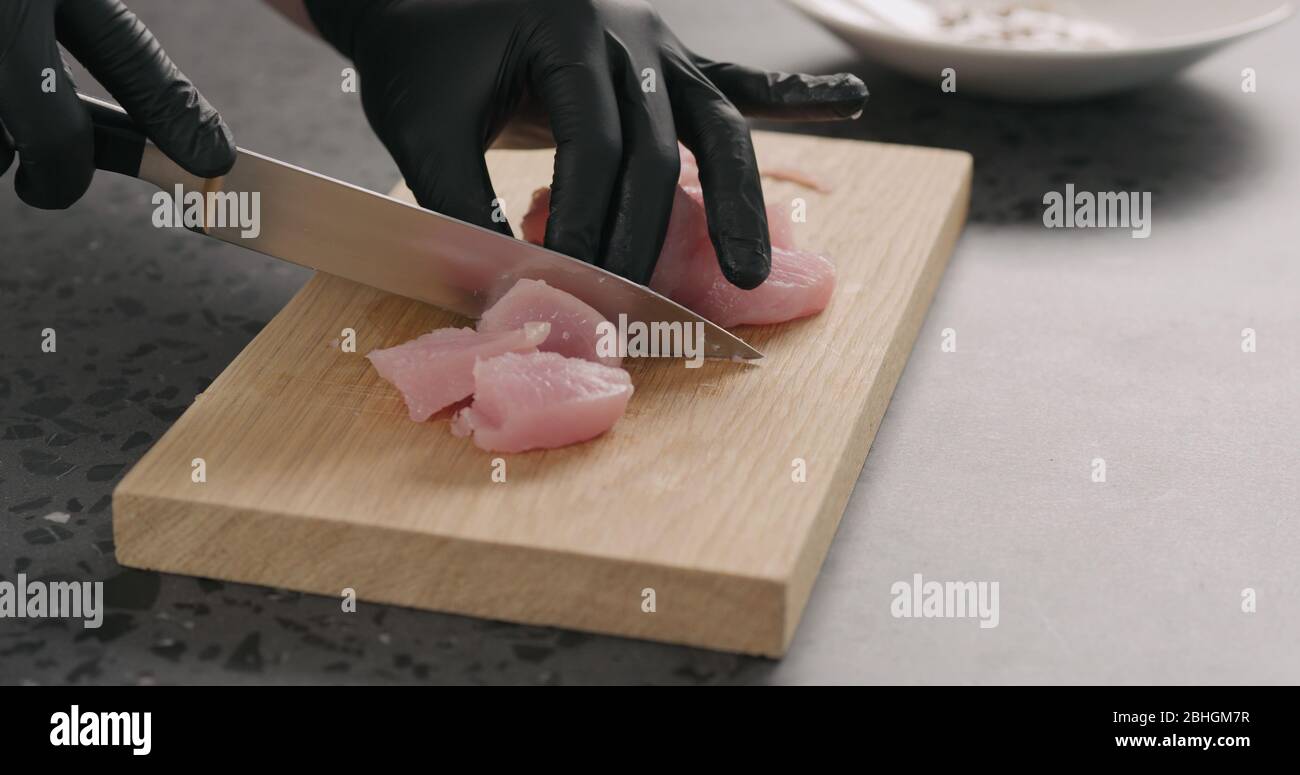 man hands slicing turkey fillet on oak board Stock Photo - Alamy