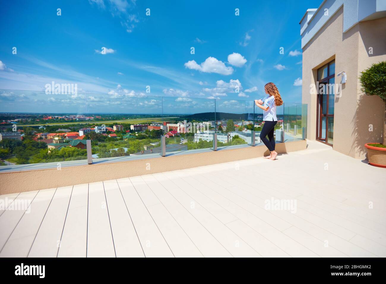 girl enjoying beautiful view on city in valley standing on modern ...