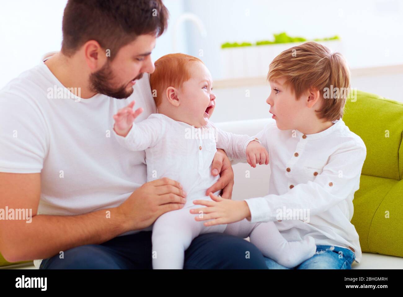 family sotthing the crying infant baby boy Stock Photo - Alamy