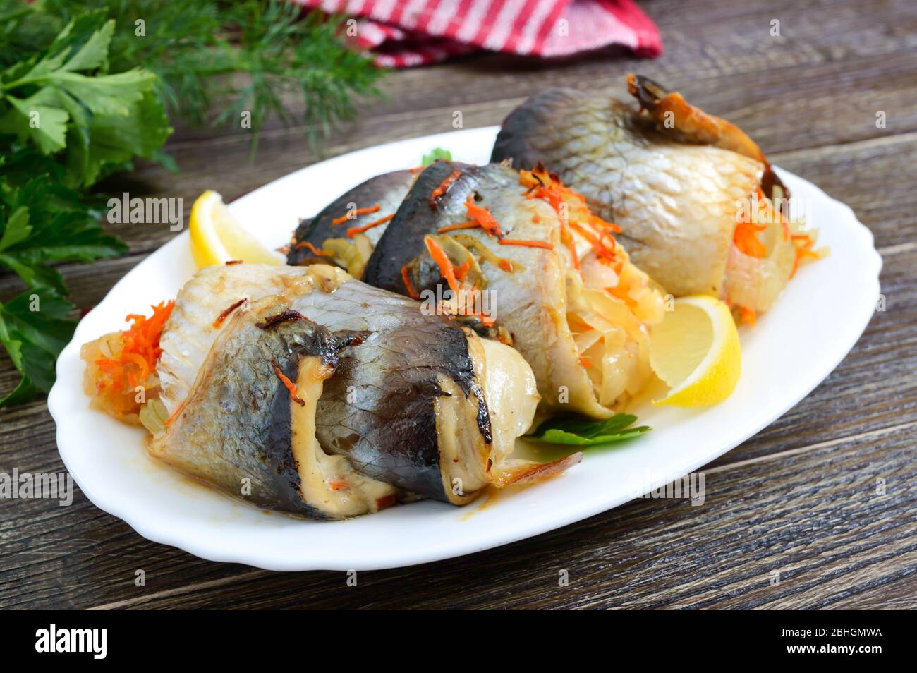 Baked herring stuffed with vegetables. Tasty fish rolls Stock Photo - Alamy