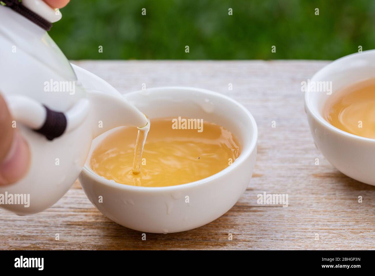 Man hand pouring Tea on Chinese tea cup. Chinese Traditional culture of ...