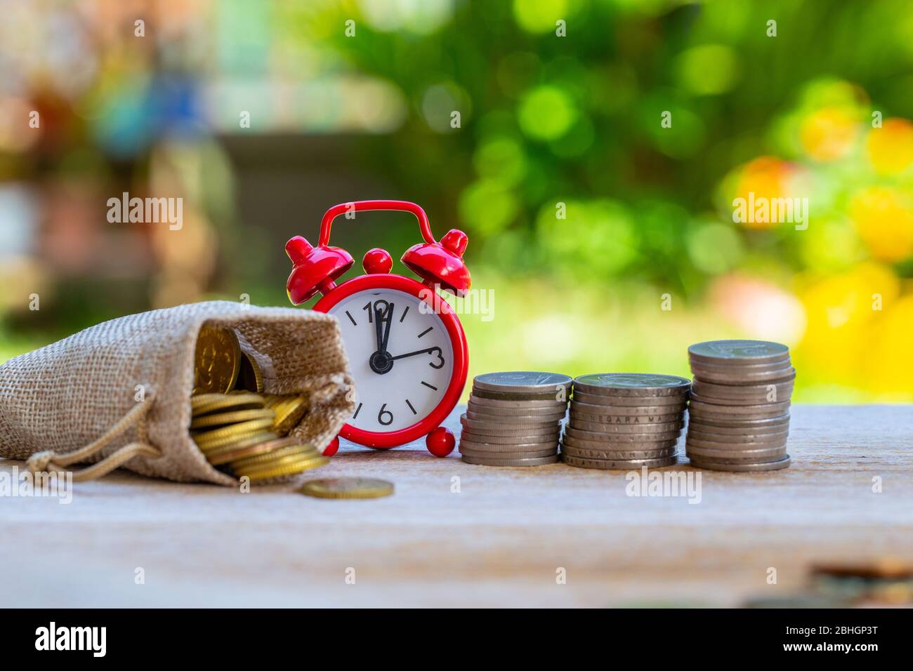 sack bag and Malaysia Ringgit coin on wooden table.- Saving Concept ...