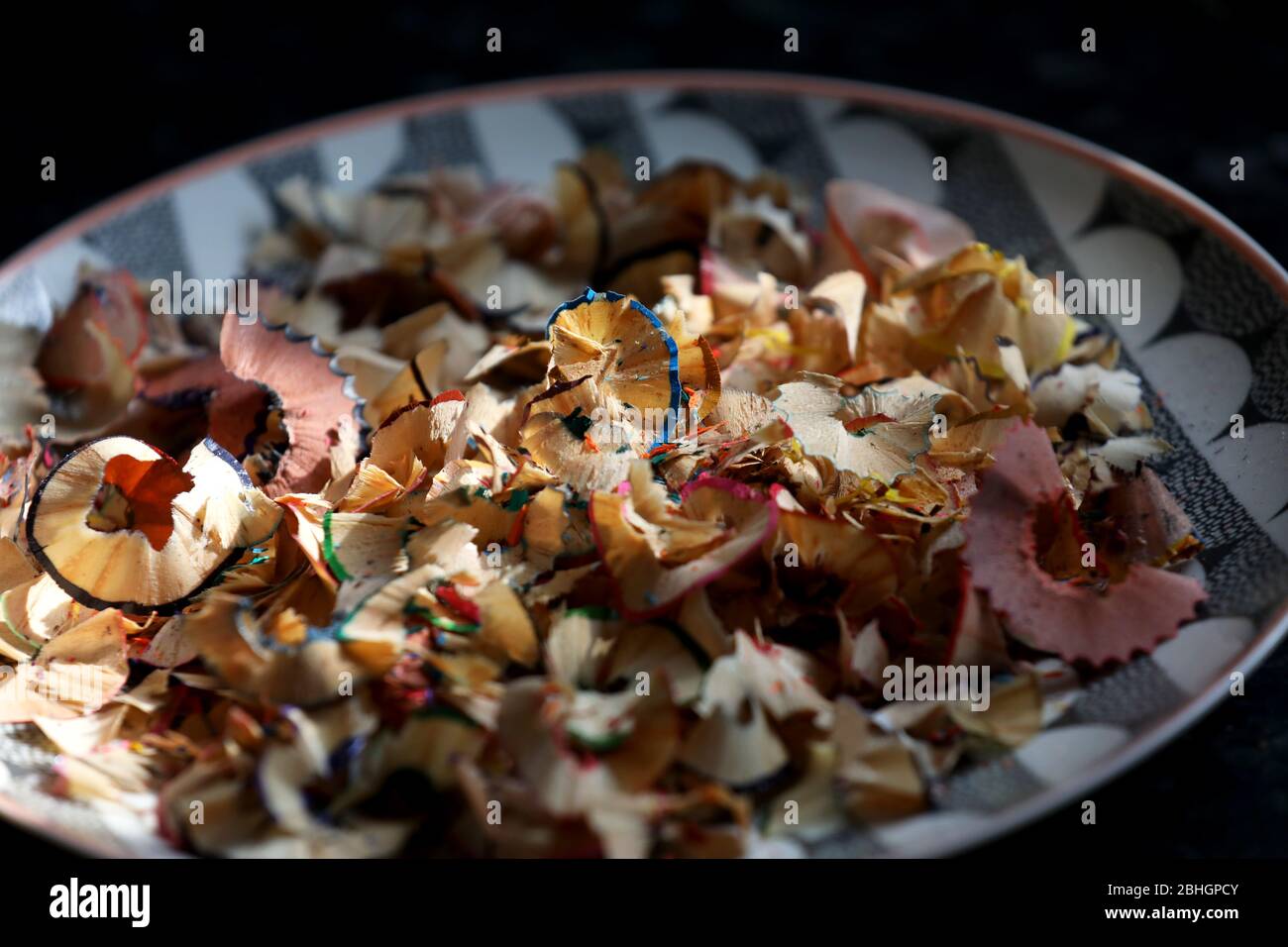 Coloured pencil sharpening's / shavings in an artists studio in London ...