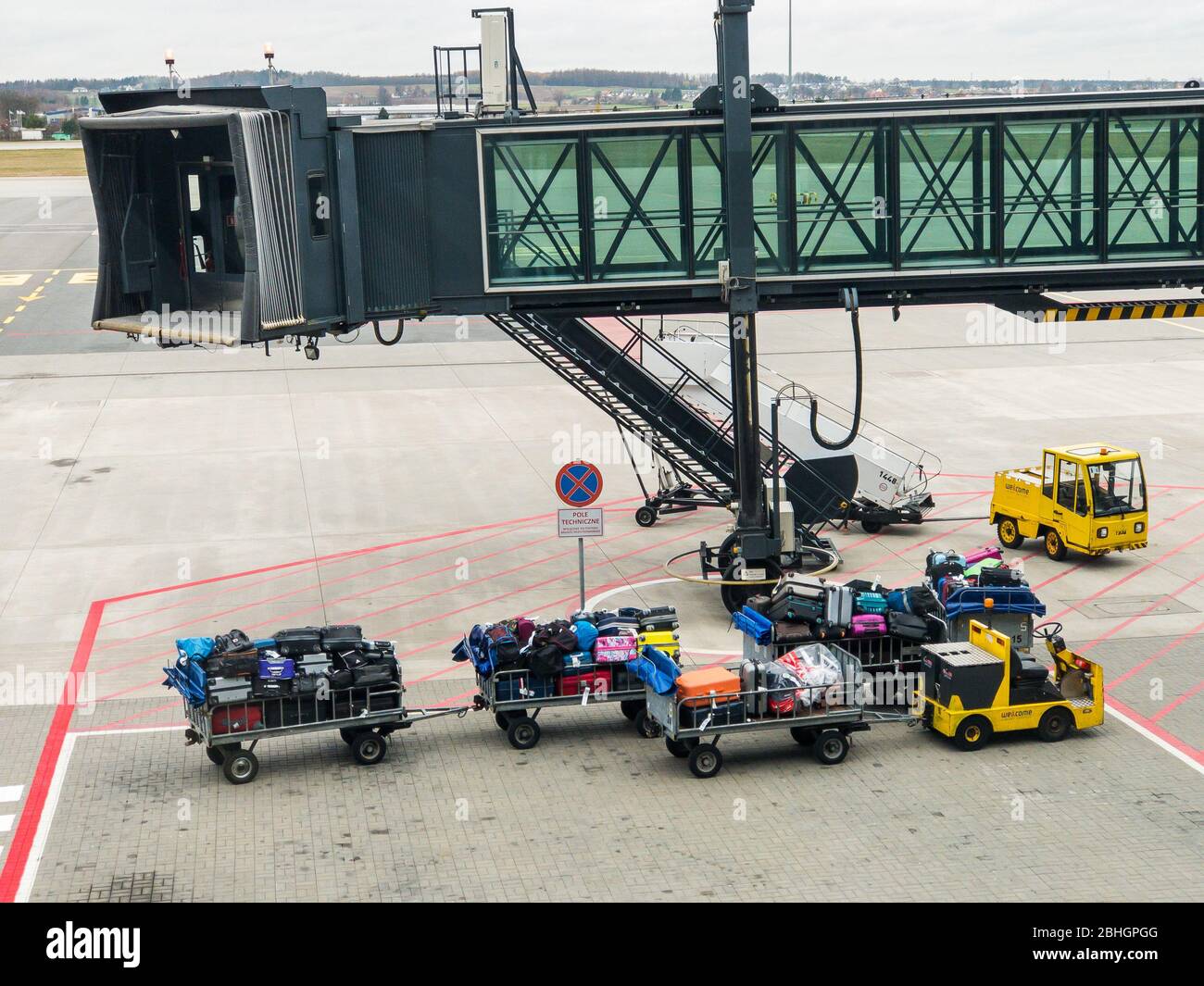 Loader carries passengers luggage at the airport Stock Photo - Alamy