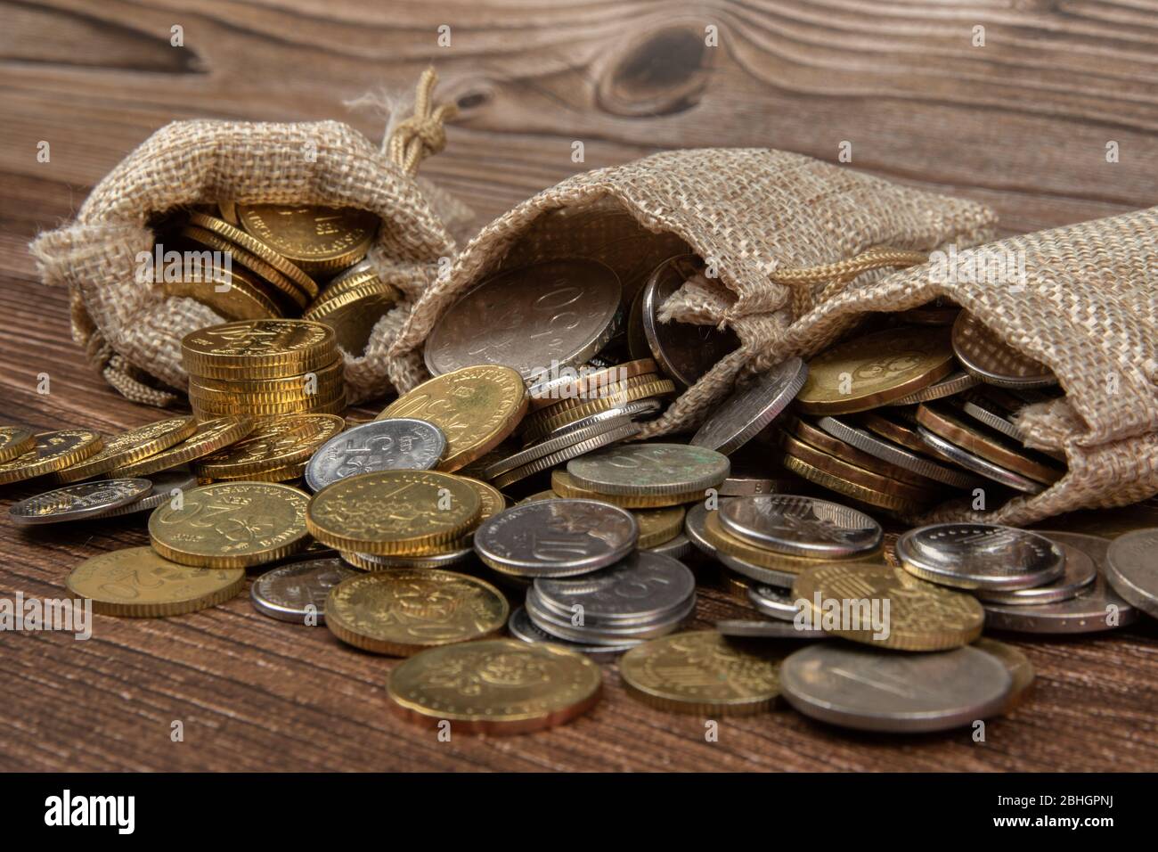 sack bag with Malaysia Ringgit coin on wooden table.- Saving Concept ...