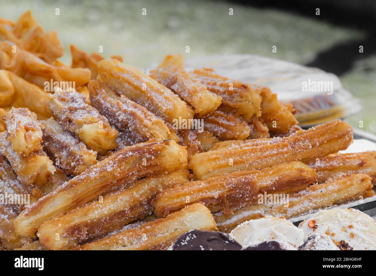 sweet churros and alfajores for sale at the street fair Stock Photo - Alamy