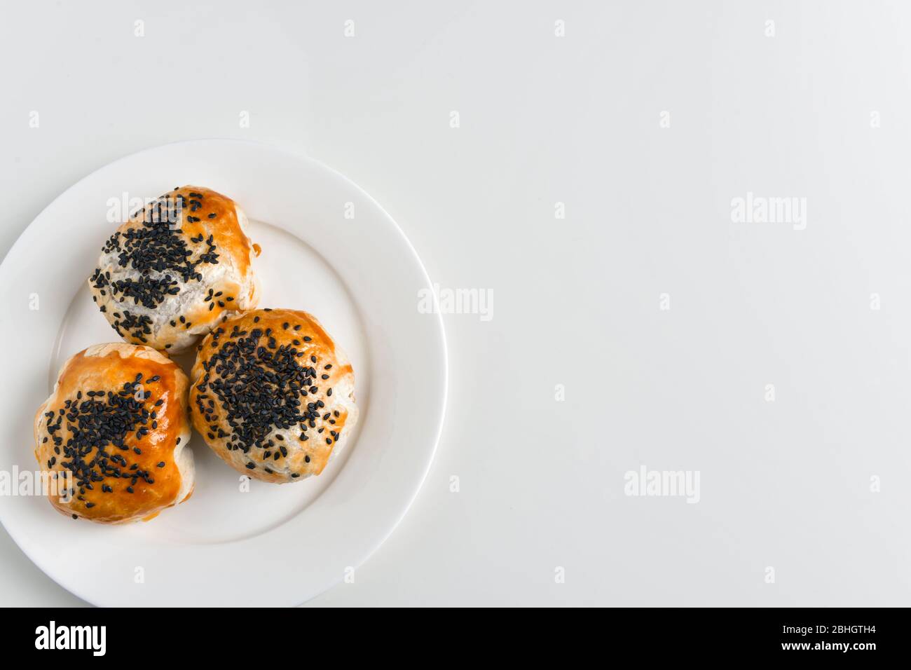 Chinese red bean paste cakes on ceramic plate, isolated on white ...