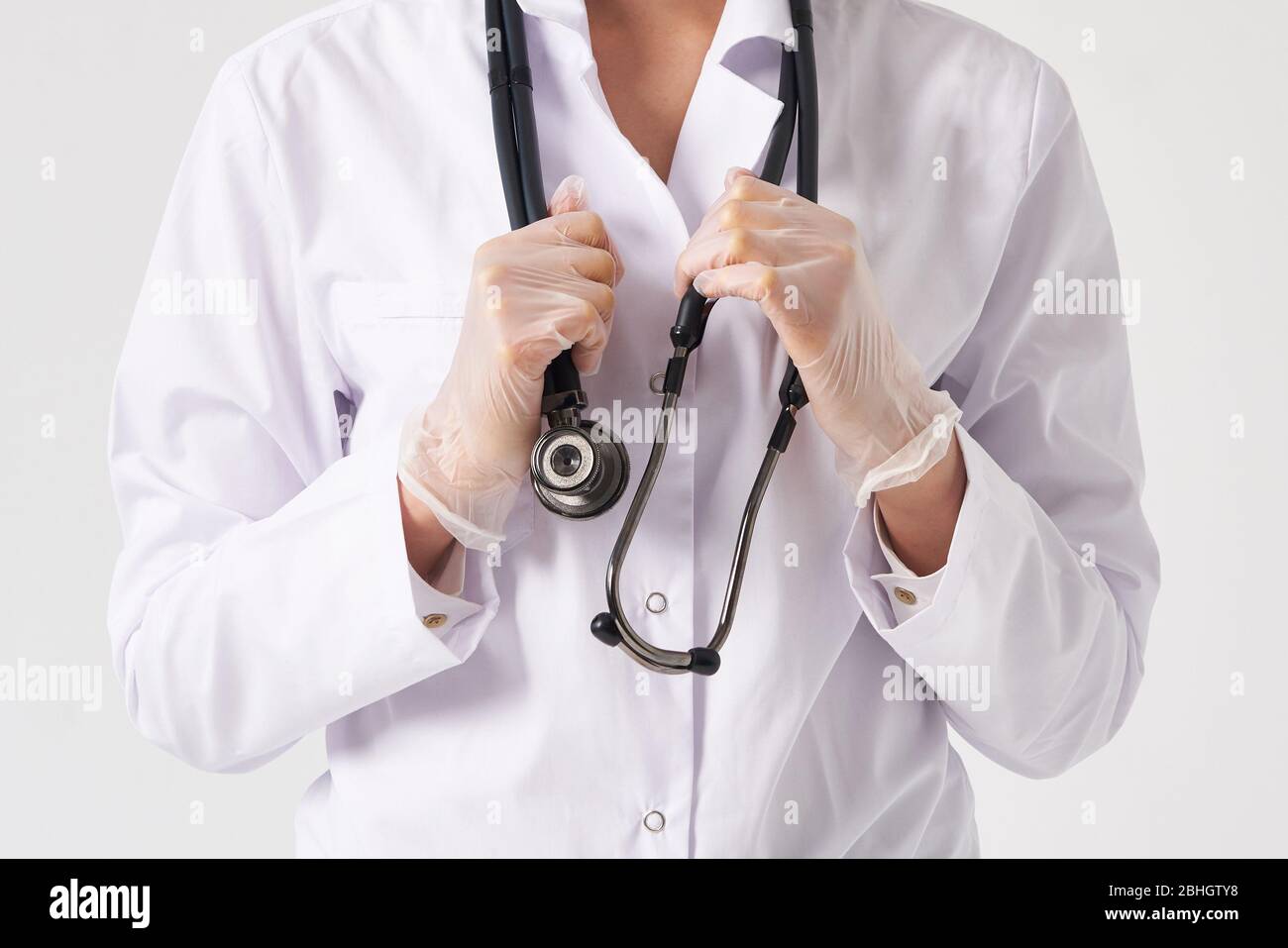 Cropped view of young female doctor holding stethoscope hanging on her ...