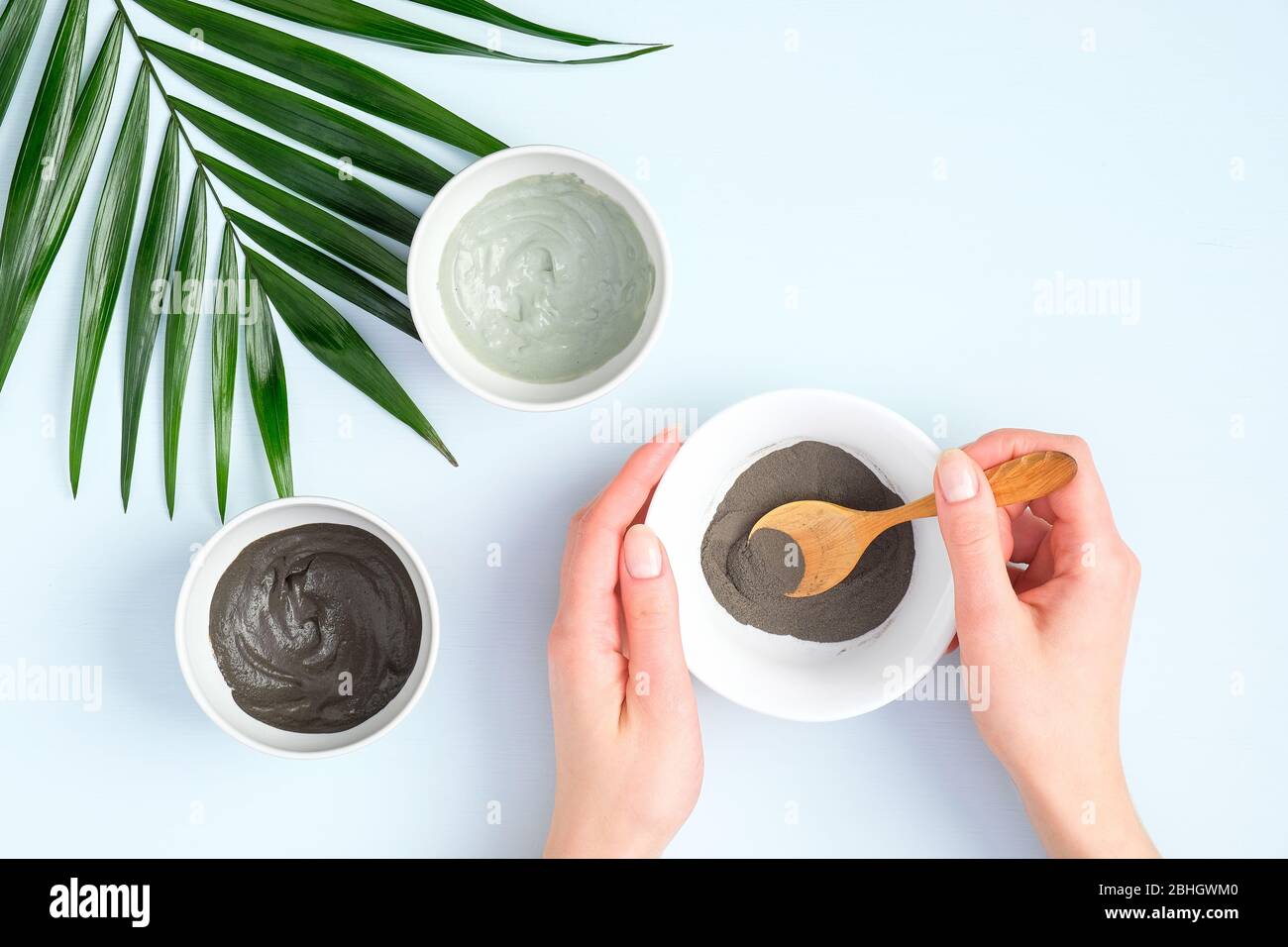 Female preparing face clay masks, top view. Facial skincare, SPA ...