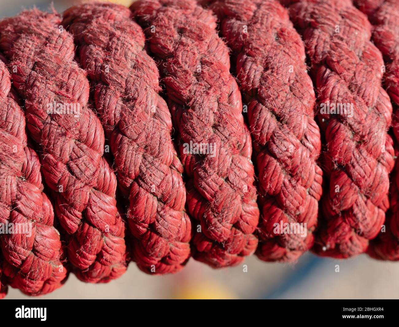 The rope for the boat laid in the form of a spiral. Thick black rope ...