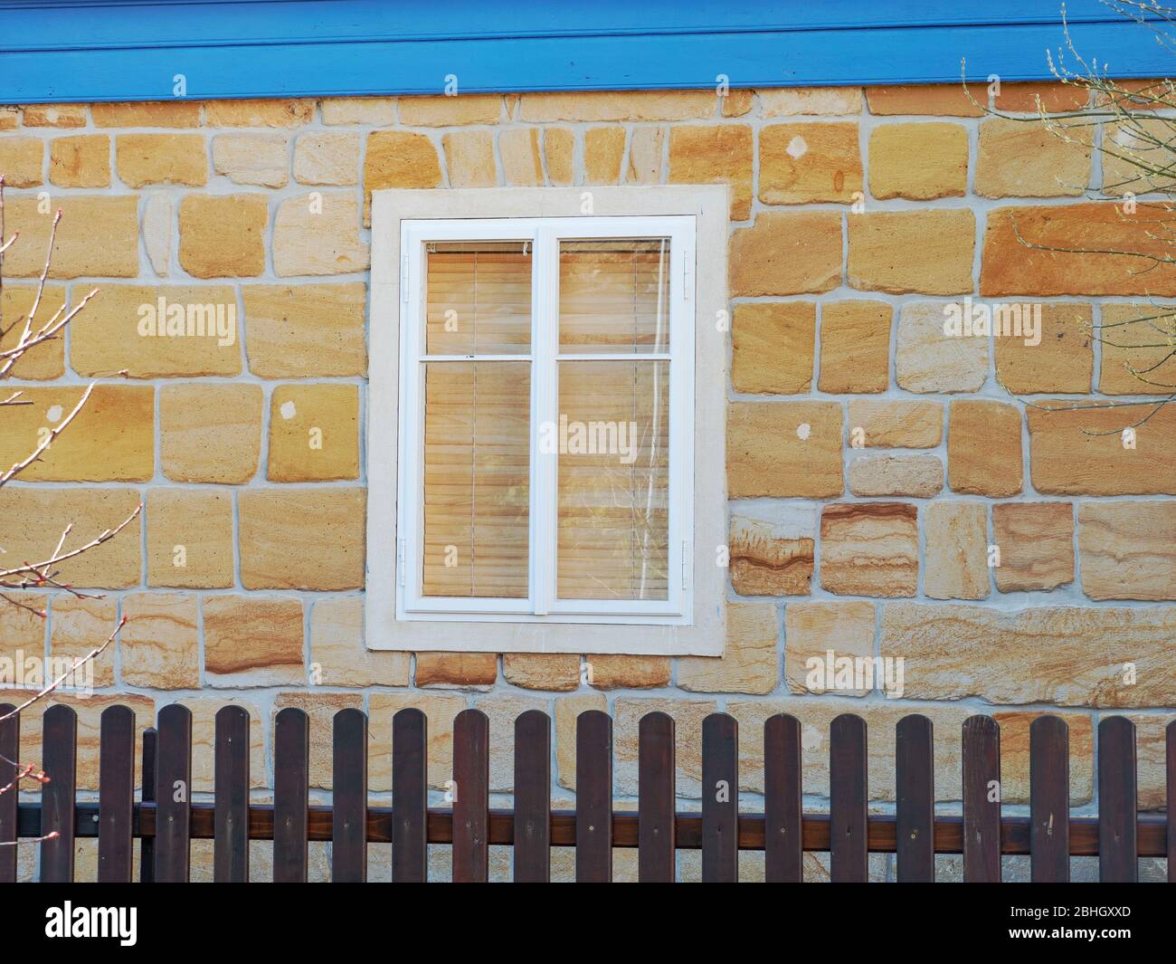 Original sandstone house with renovated wall and new modern plastic ...