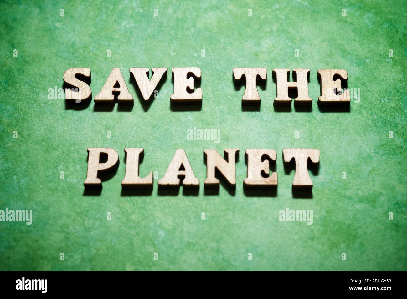 Save the planet text on a green paper Stock Photo - Alamy