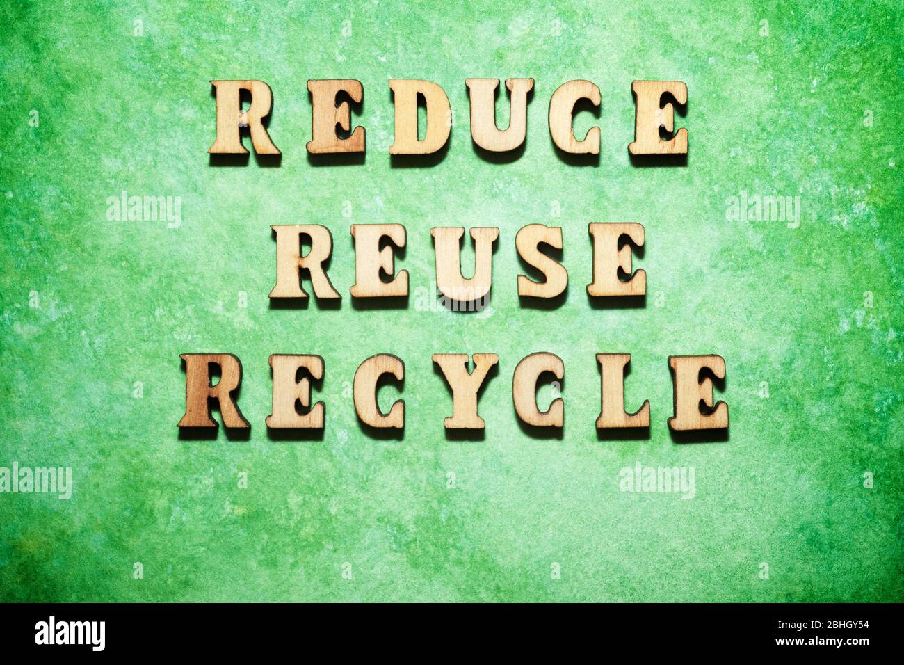 Reduce, Reuse and Recycle words on a green table Stock Photo - Alamy
