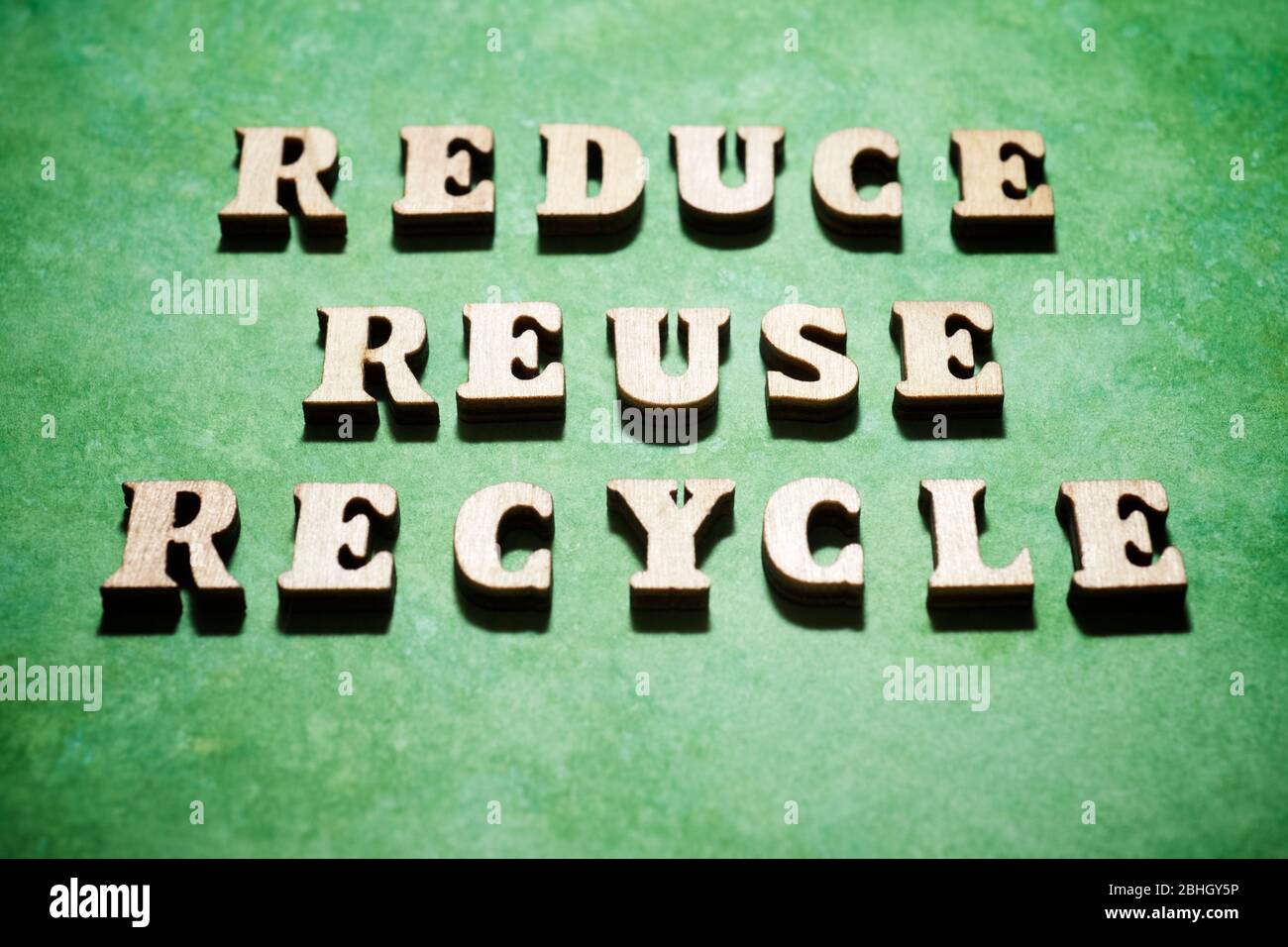 Reduce, Reuse and Recycle words on a green table Stock Photo - Alamy