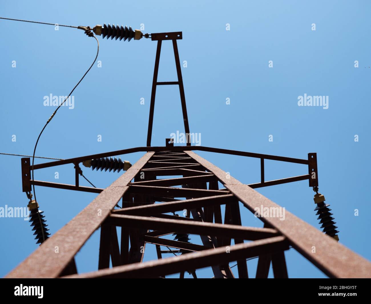 Old rusty construction of high-voltage pole against the sky, high ...