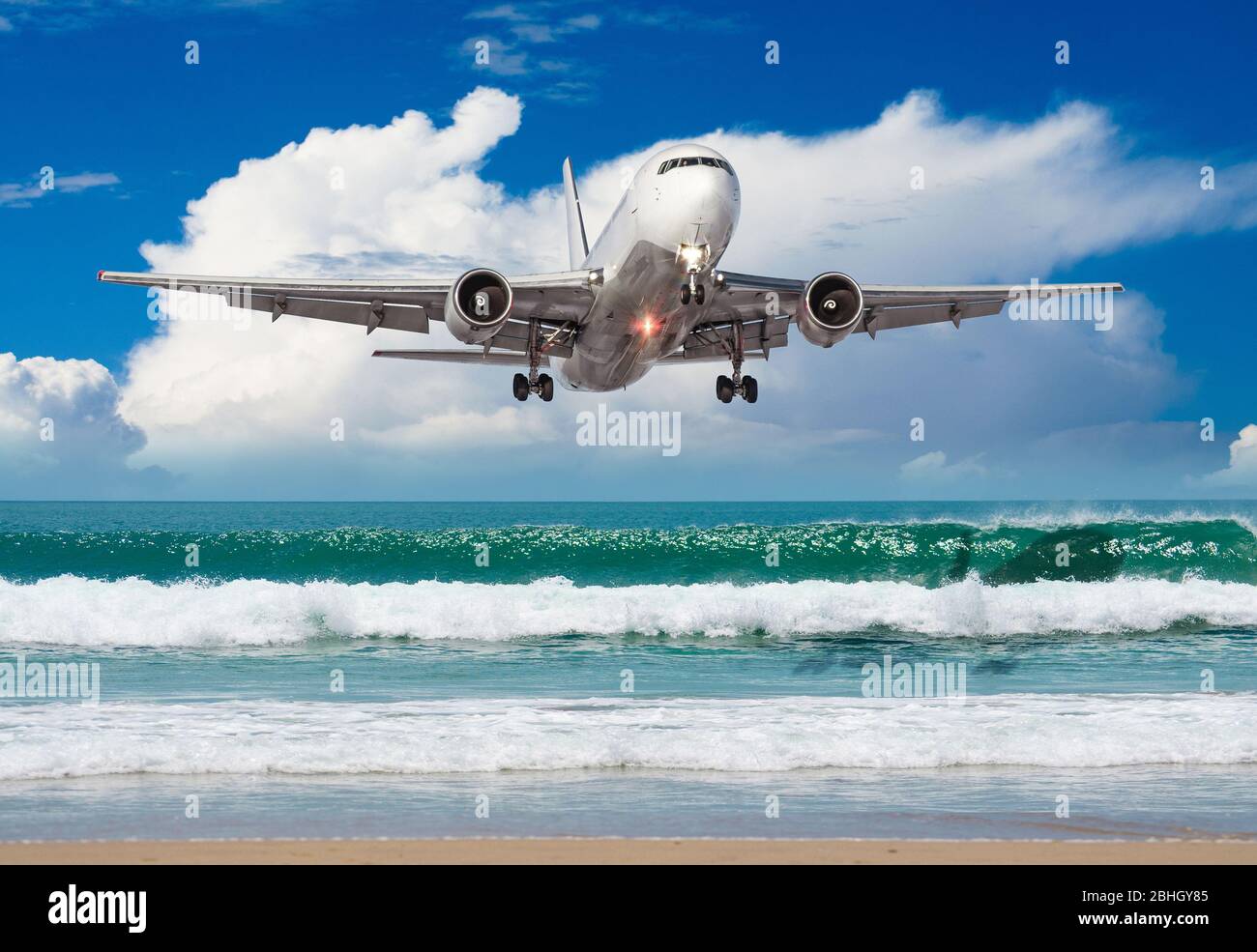 Large plane approaches the landing at the airport low over a tropical ...