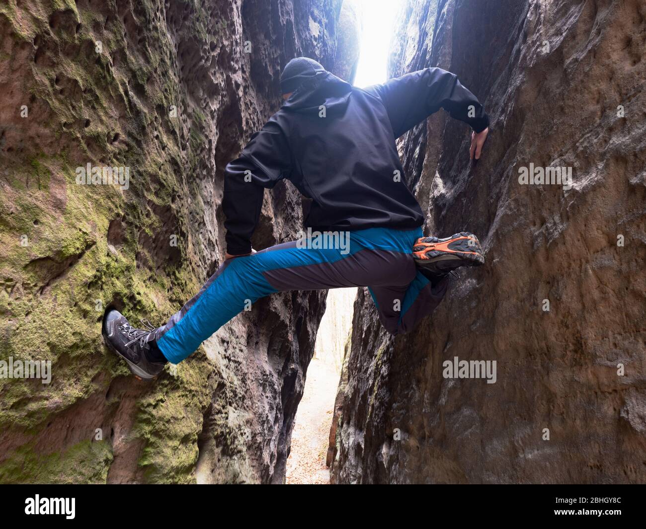 Man climbing from ground to the light above head. Thin distance between ...