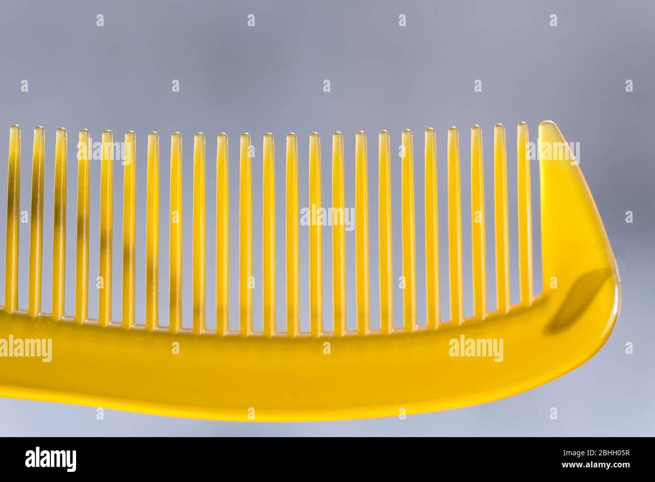 yellow color plastic comb on white background Stock Photo - Alamy