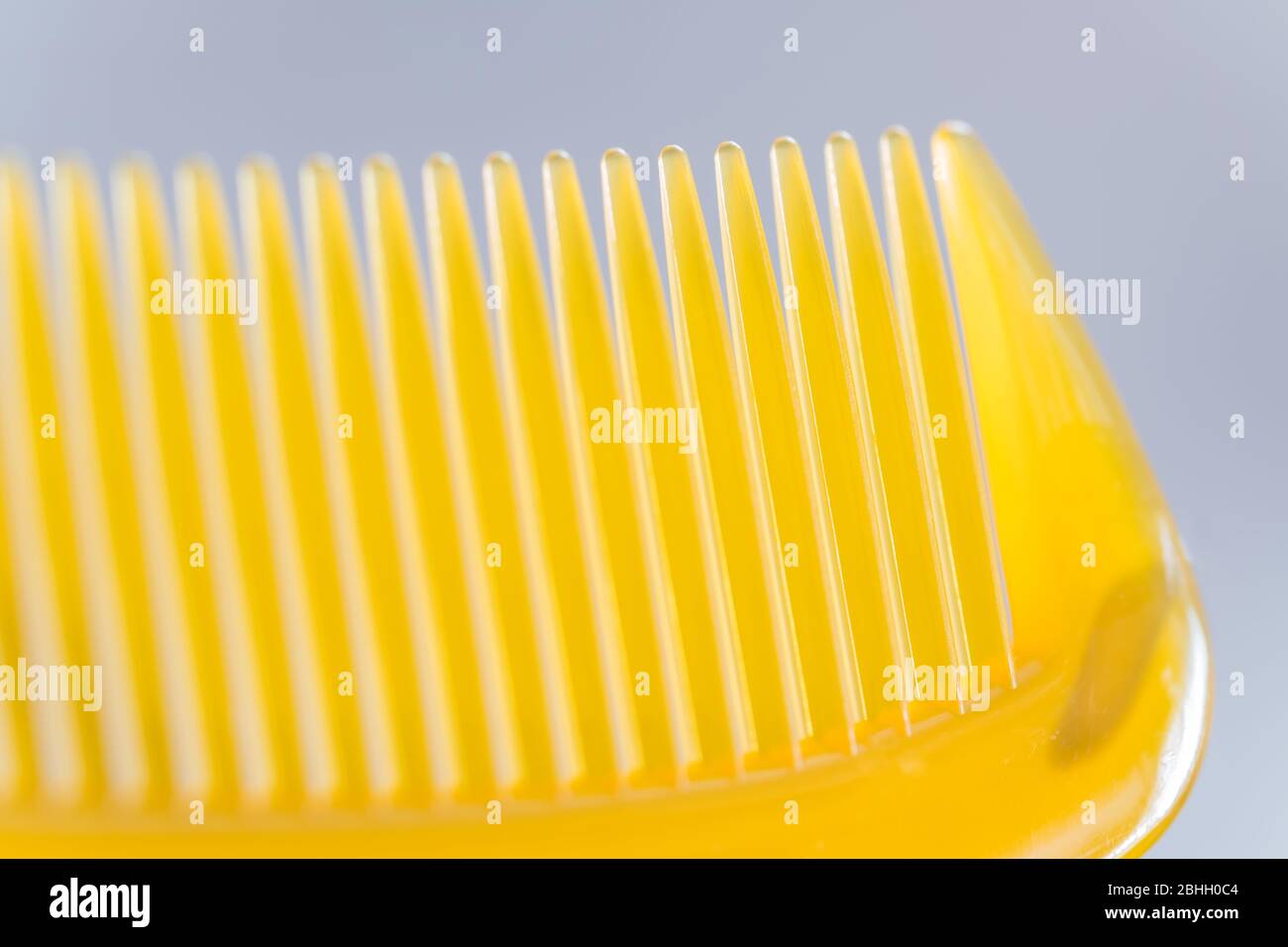 yellow color plastic comb on white background Stock Photo - Alamy