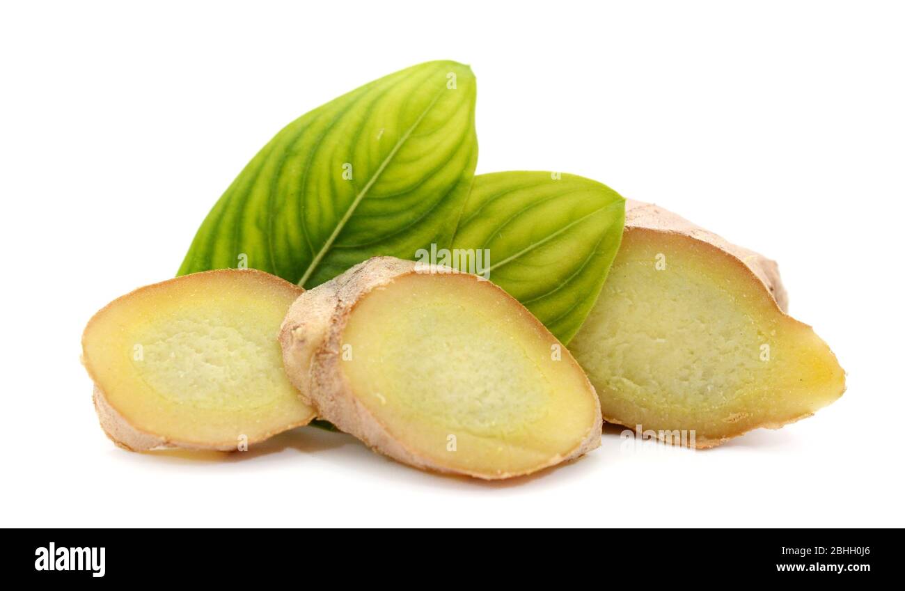 Ginger and cut ginger slices on table Stock Photo - Alamy