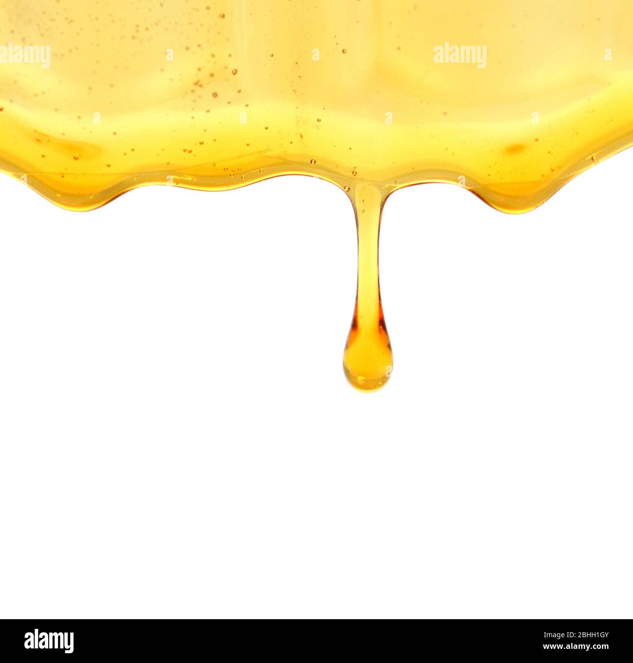 Flow of sweet honey on the white background Stock Photo - Alamy