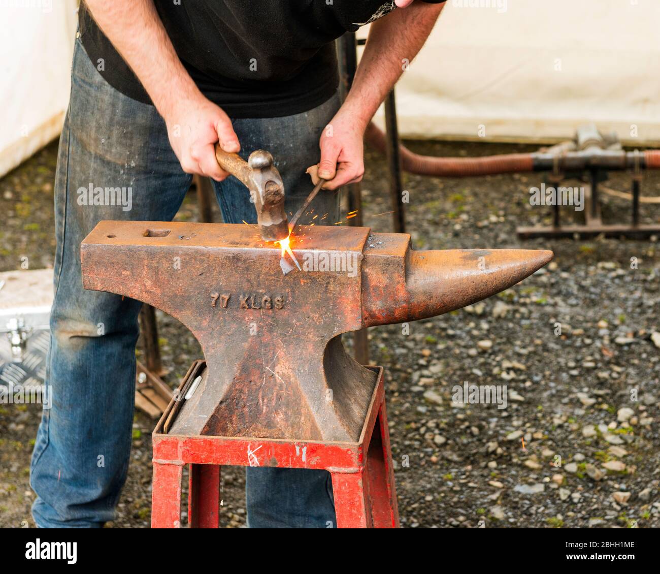 A blacksmith demonstrates traditional skills at Sticklepath, Devon ...