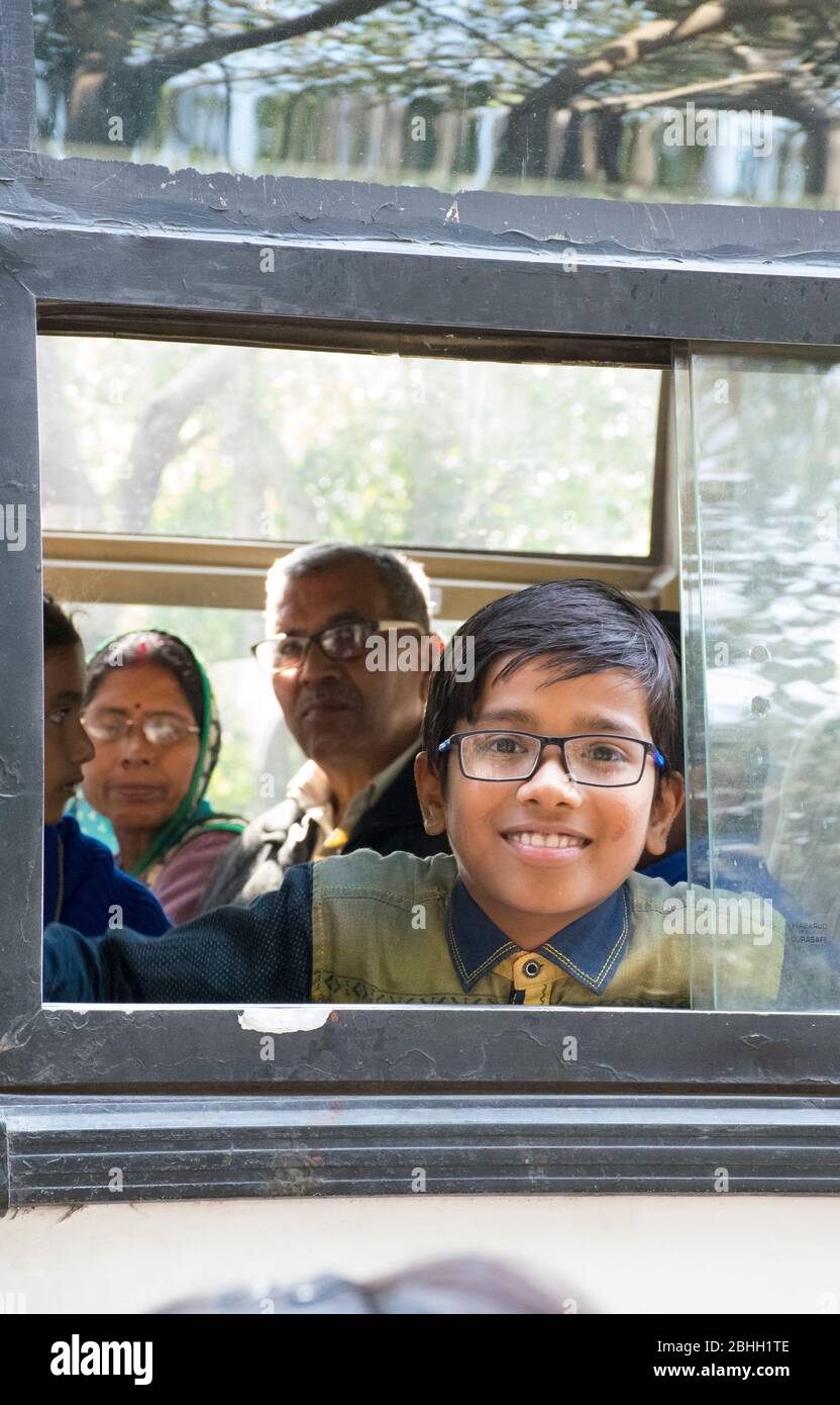 boy looking through bus window Stock Photo - Alamy