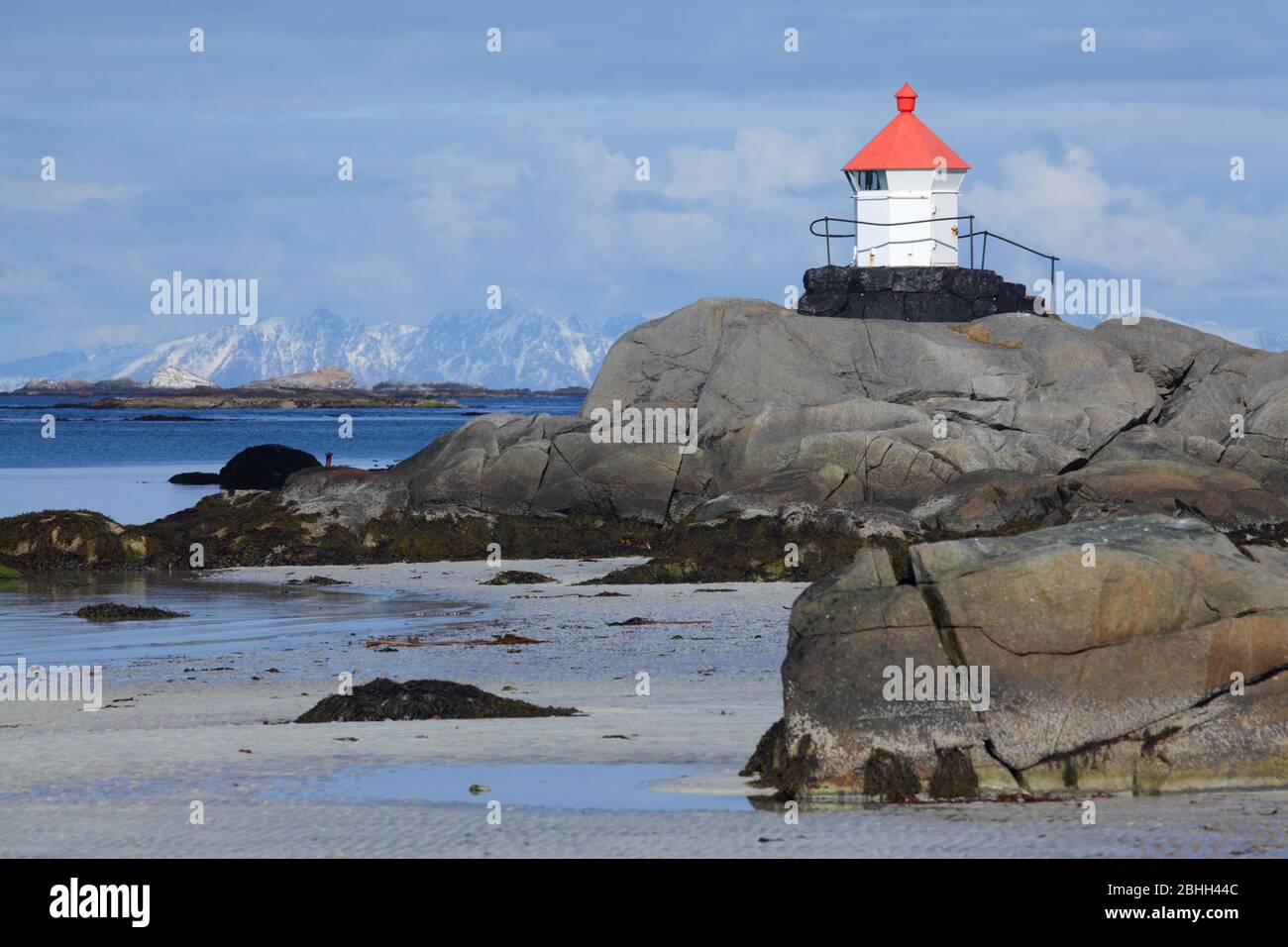 Traditional barn beside mountain lake near Leknes in the Lofoten ...