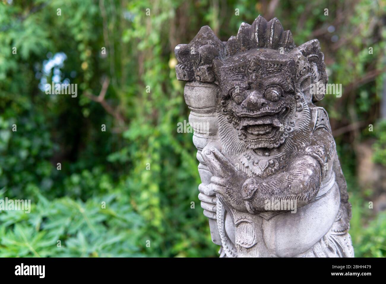 A balinese statue stands alone in bali Stock Photo - Alamy
