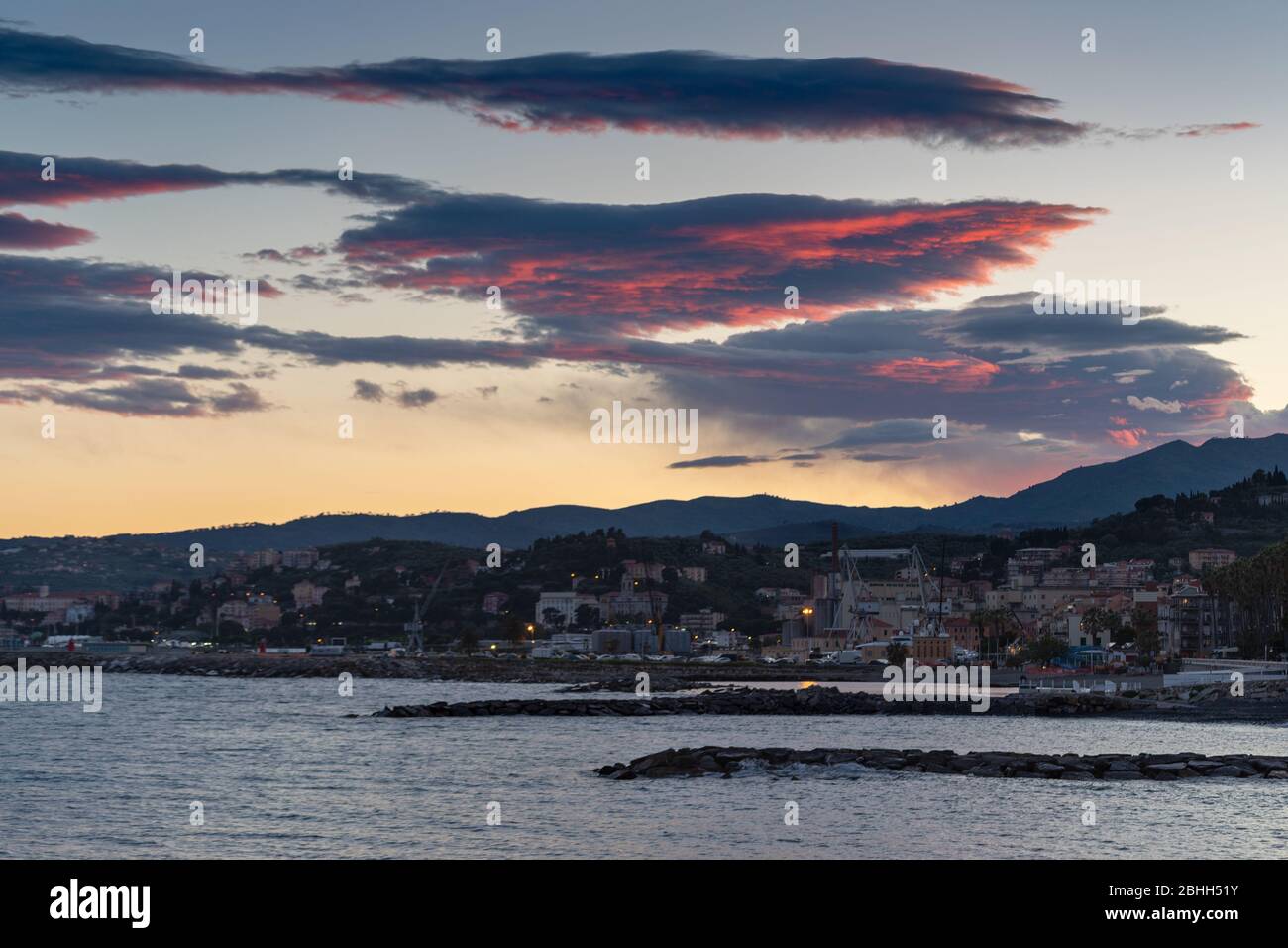Colorful clouds at sunset with cityscape - Imperia, Liguria, Italy ...
