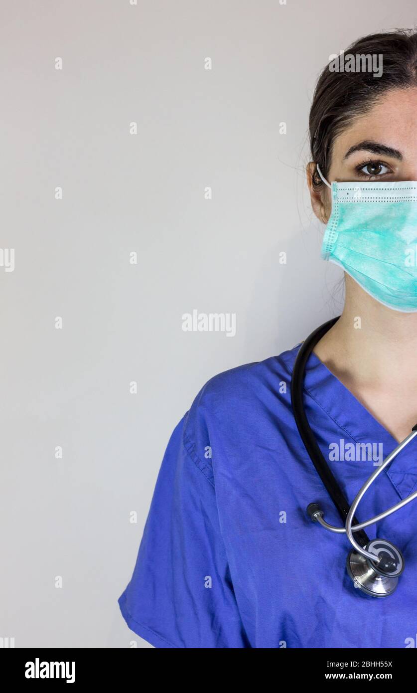 Female doctor in working pajamas with mask for respiratory protection ...