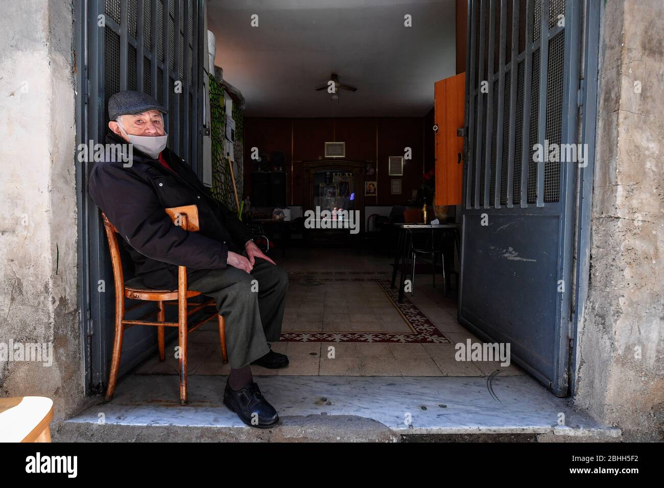 Elderly man wearing a protective mask, out the door of her home, in ...
