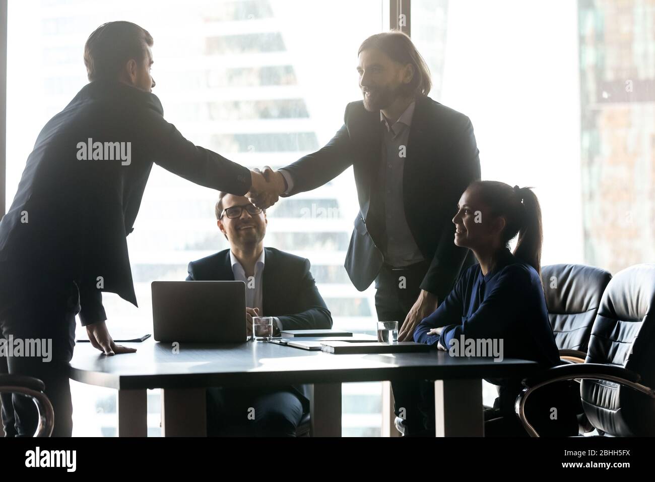 Smiling hr manager shaking successful candidate hand after interview ...