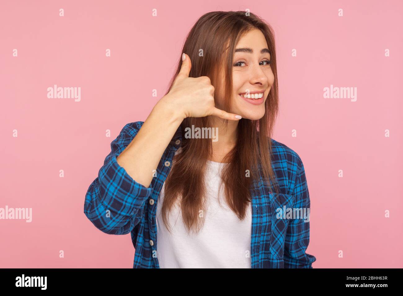 Call me! Portrait of charming happy flirtatious girl in checkered shirt ...