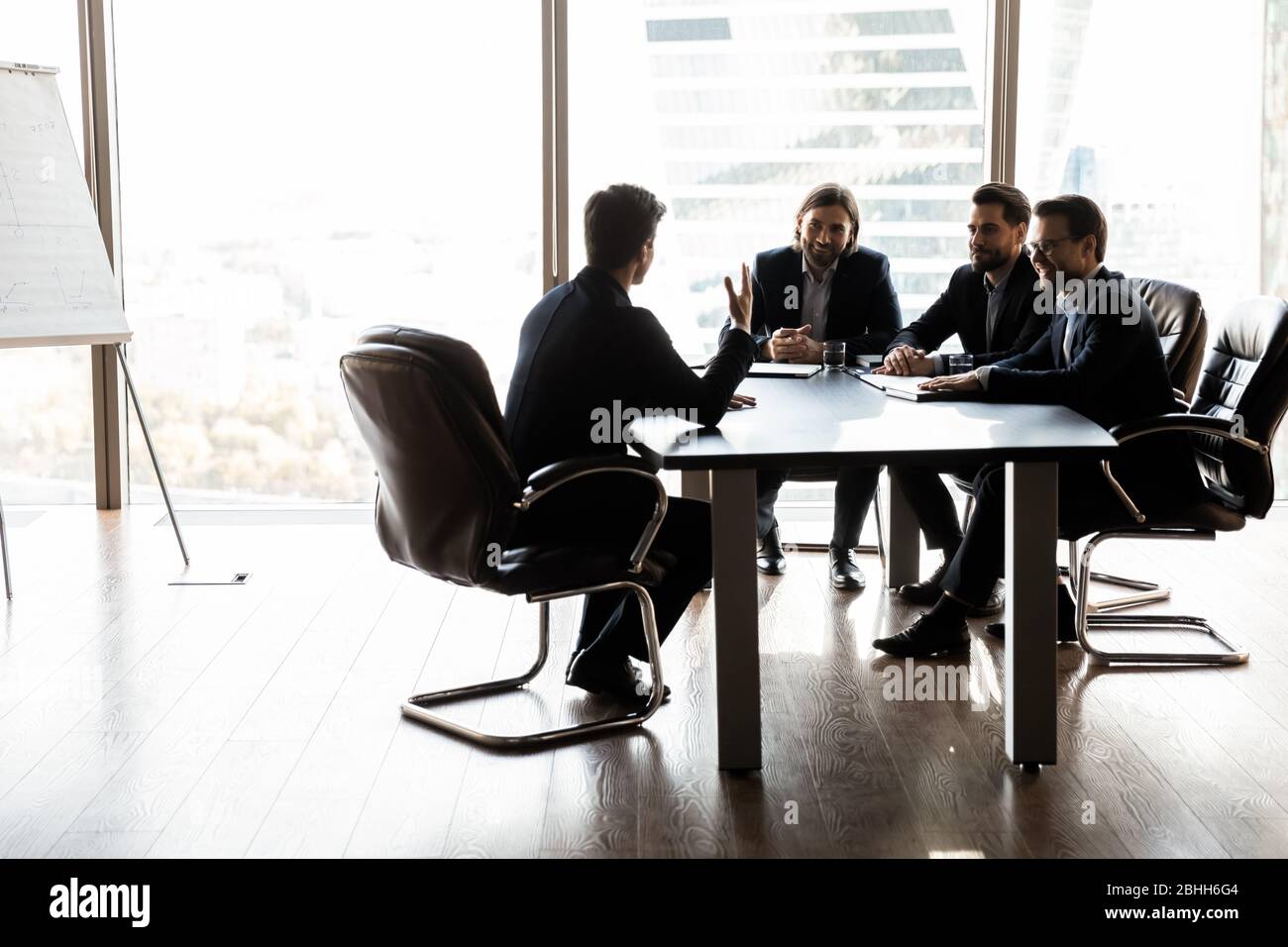 Happy colleagues having fun at meeting in boardroom Stock Photo - Alamy