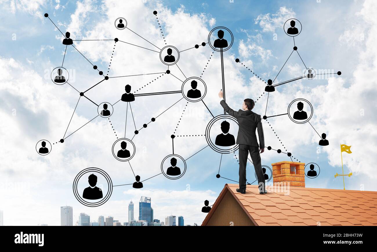 Businessman on house roof presenting networking and connection concept ...